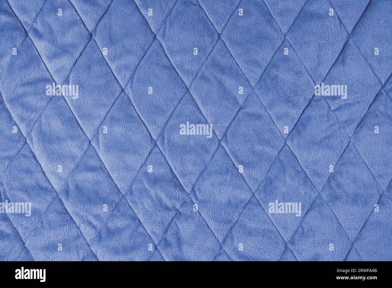 Quilted velours fabric background. Blue texture blanket or puffer ...