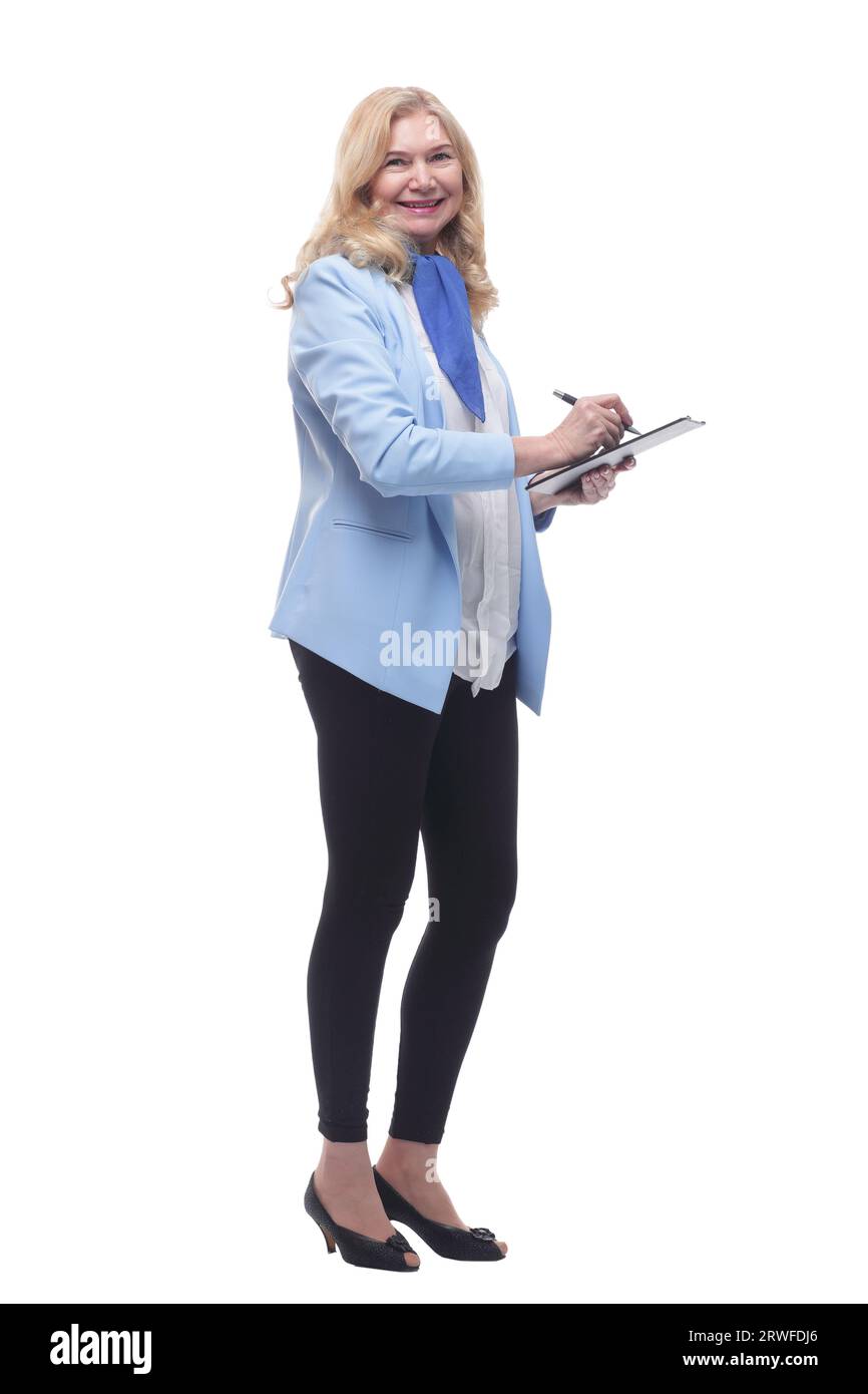 in full growth. smiling woman making a note in the clipboard Stock ...