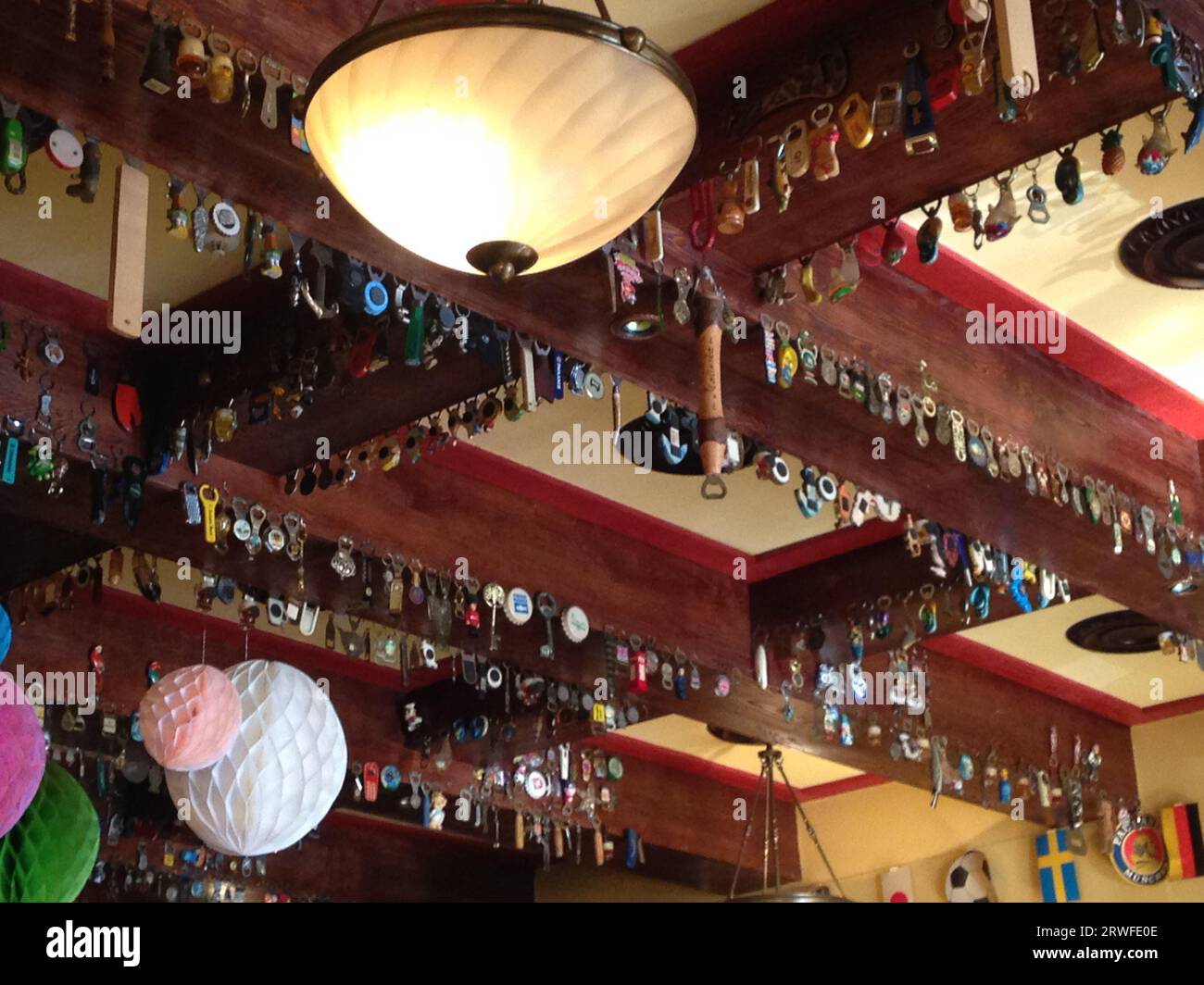 Ceiling in various bottle openers. Huge collection of beer bottle ...