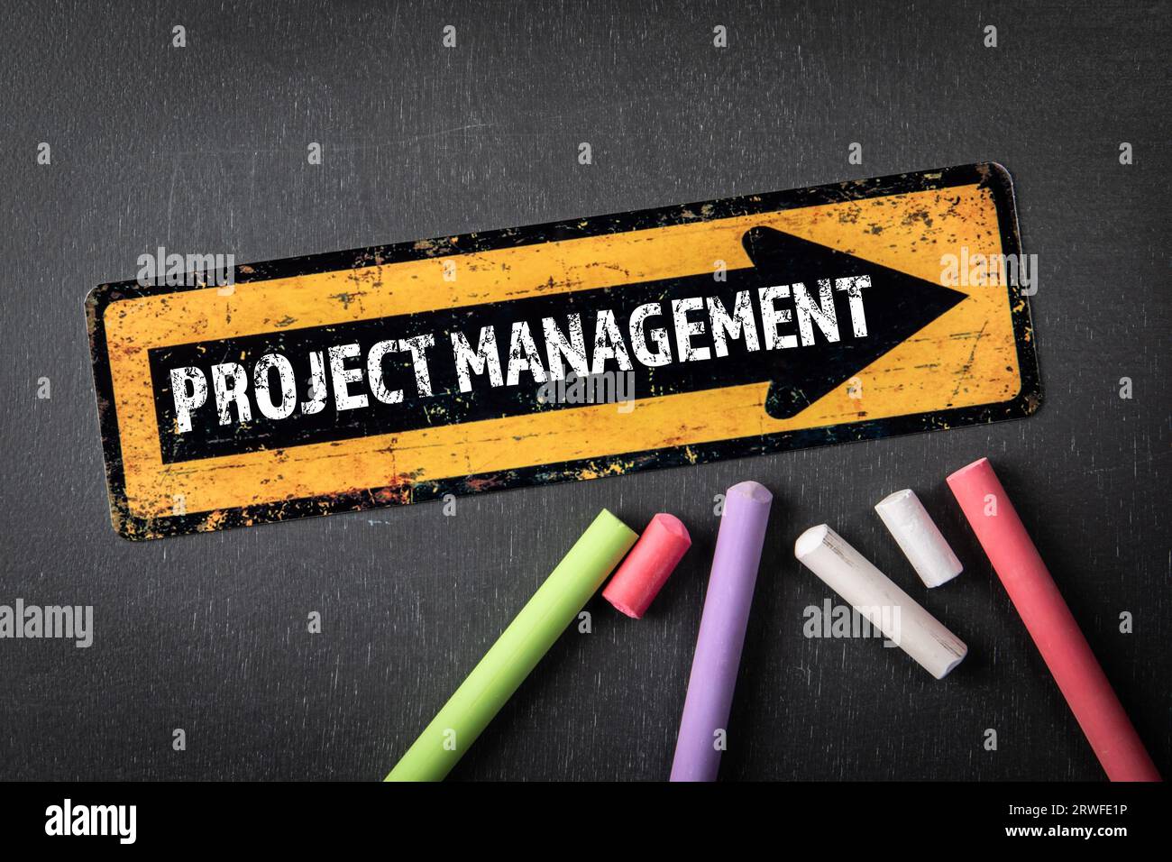 Project management. Yellow directional arrow with text on a dark ...