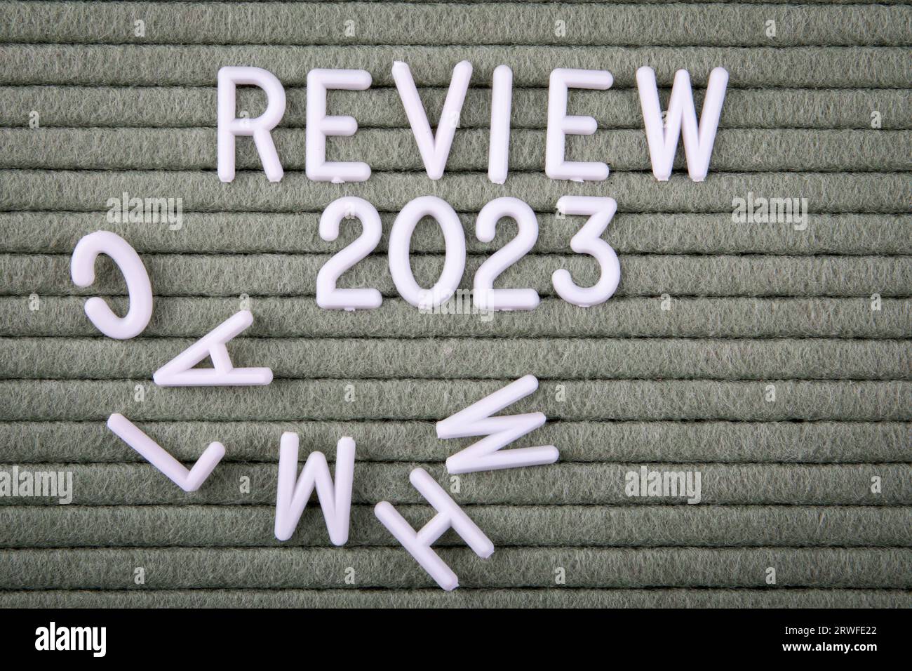 REVIEW 2023 Concept. White letters of the alphabet on a green ...