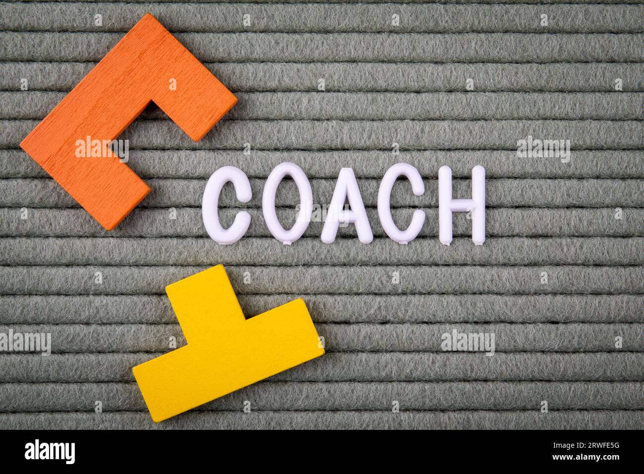 COACH Concept. White letters of the alphabet on a green background ...