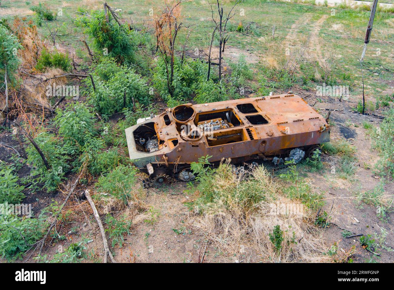 Top view of a destroyed armored combat vehicle in the countryside after ...