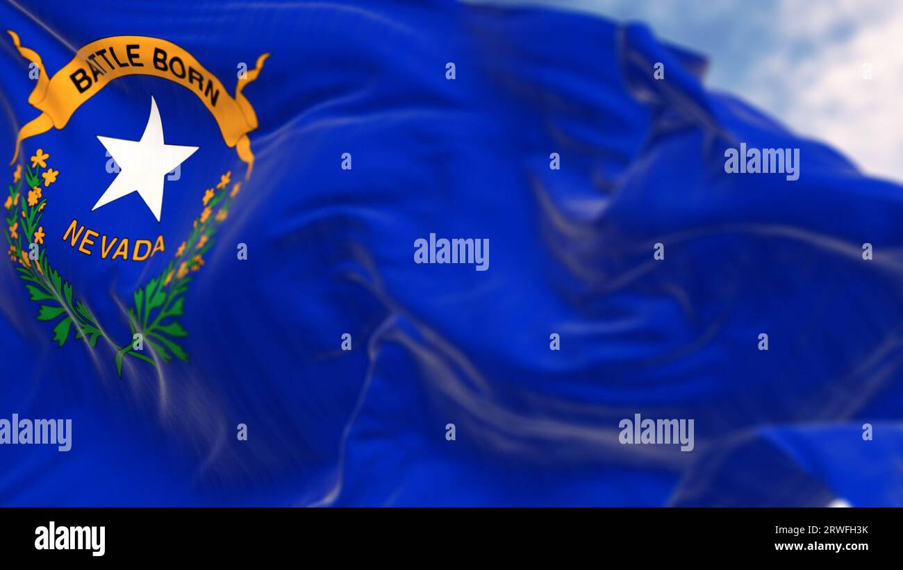 Close-up of Nevada state flag waving in the wind on a clear day. Cobalt ...