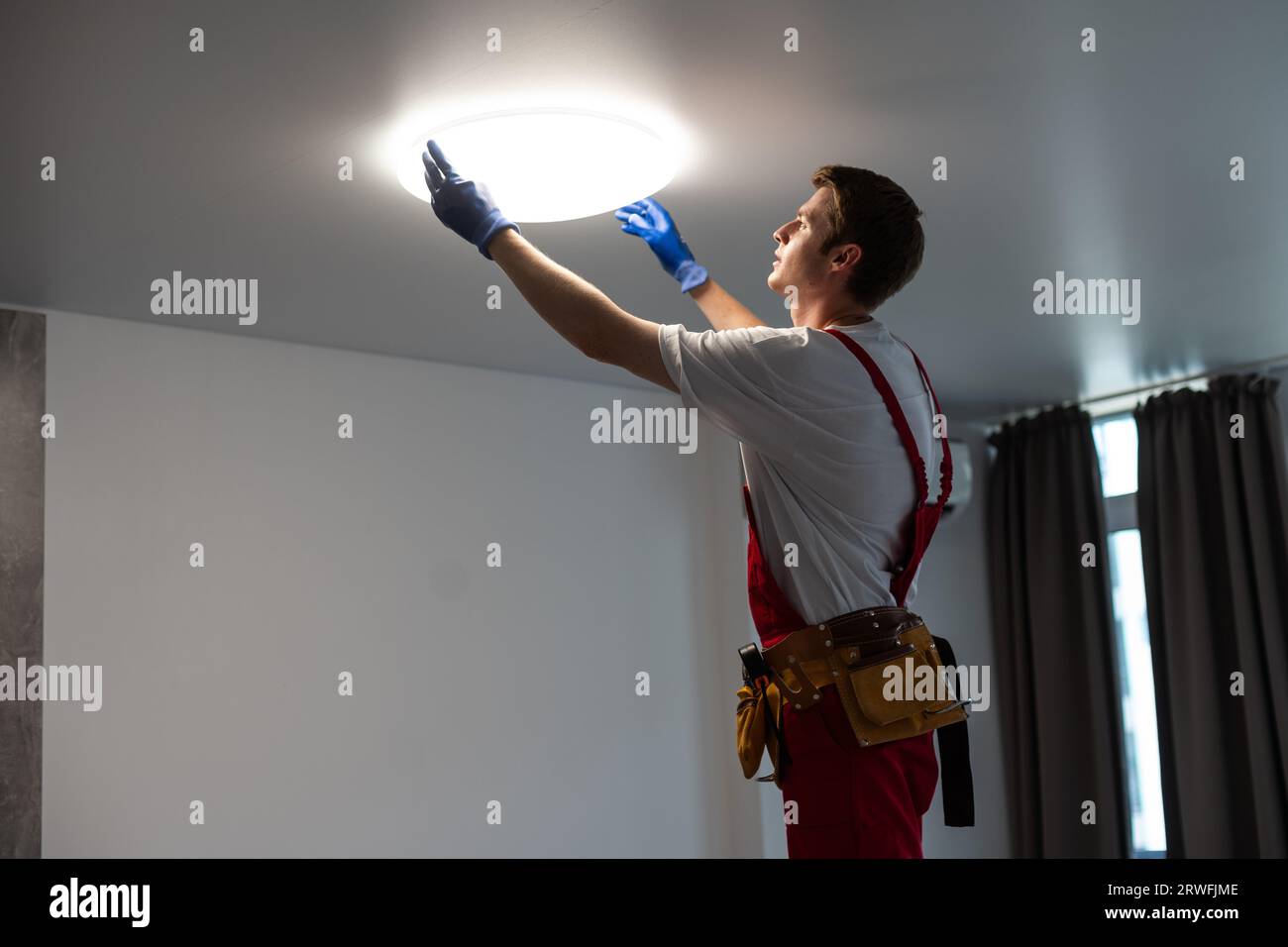Electrician at work. Service for the repair of electrical wiring and ...