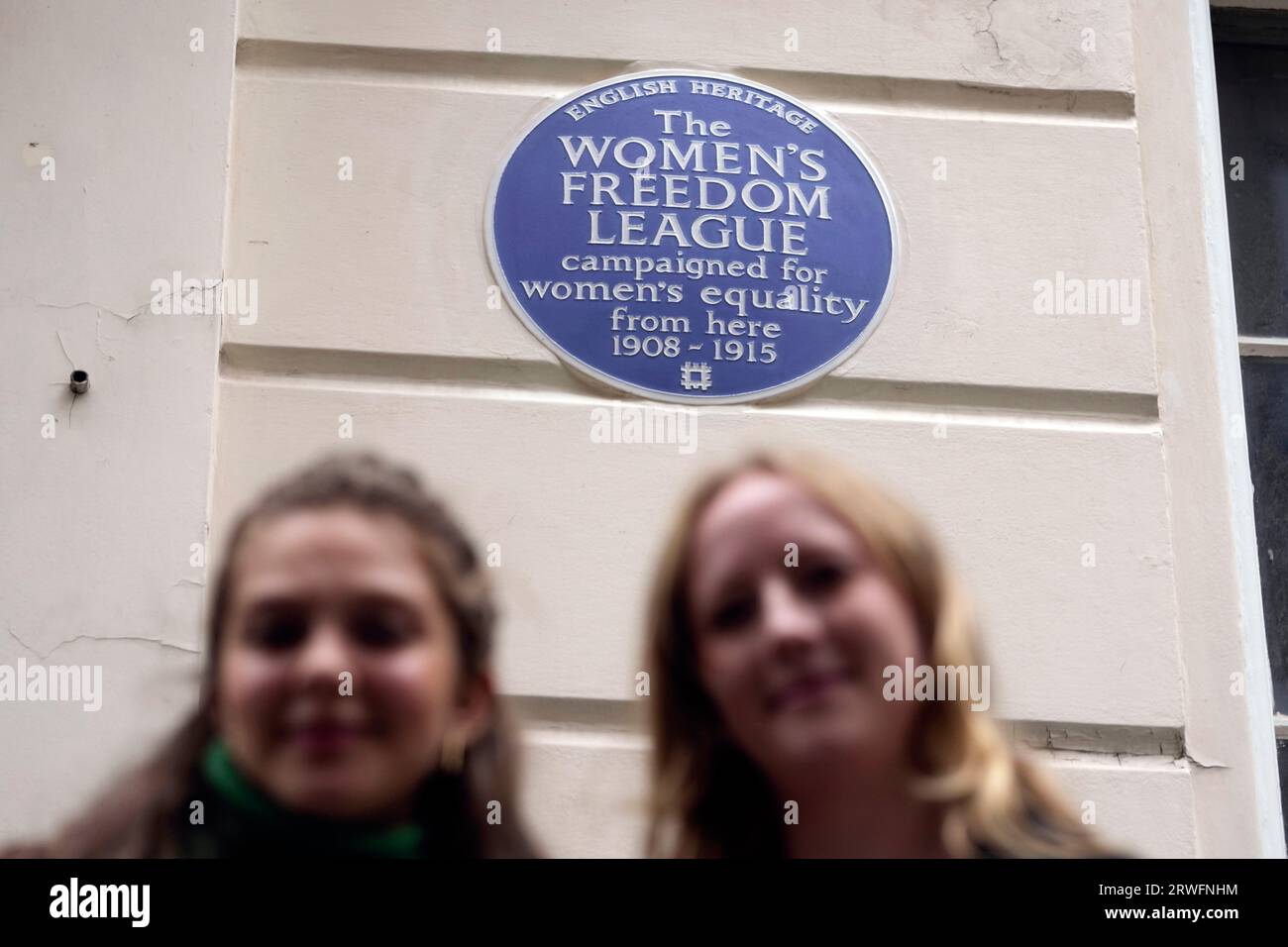 Guests pose for a photograph in front of the new unveiled plaque number ...