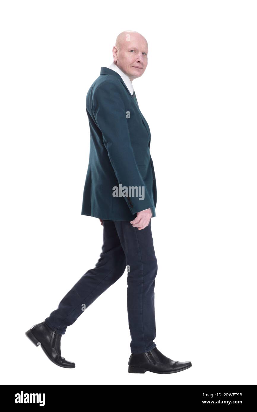 Mature business man striding forward. isolated on a white background ...