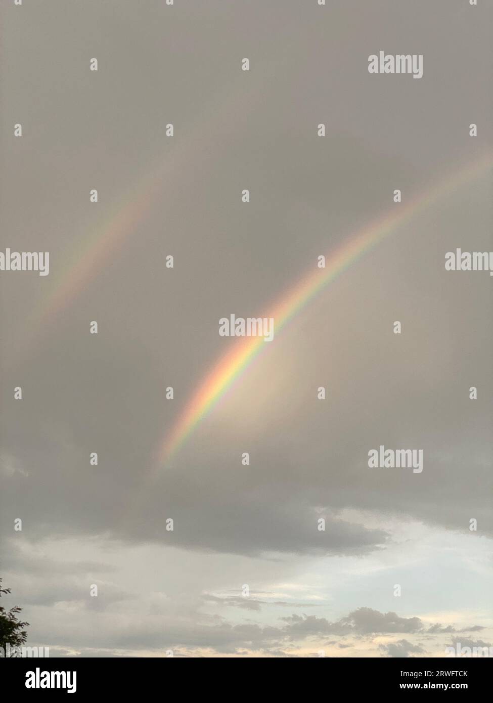 Sunset with a double rainbow arch Stock Photo - Alamy