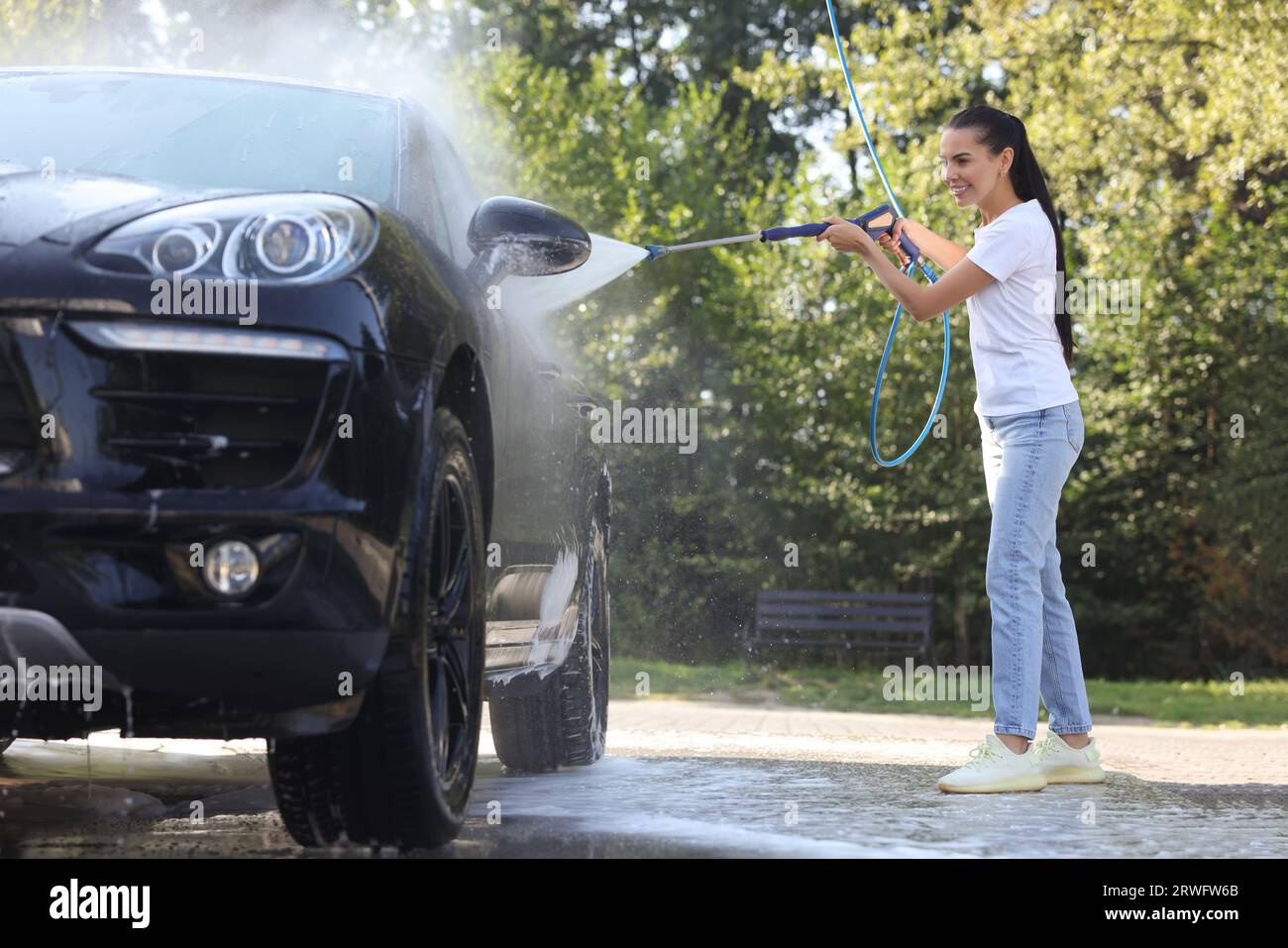 Woman jet washing car hi-res stock photography and images - Alamy