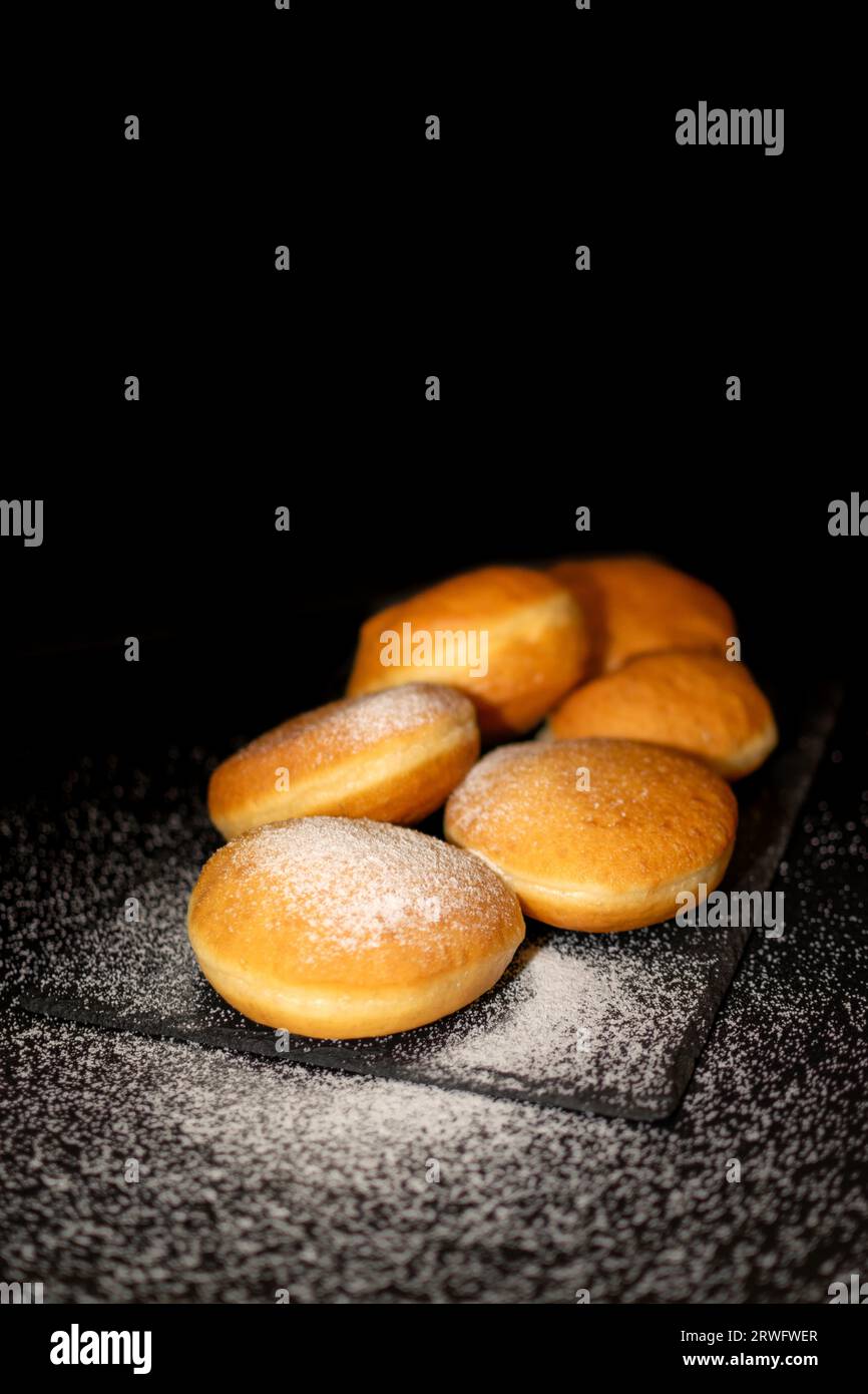 German Krapfen with drizzling glazed sprinkles in black elegant ...