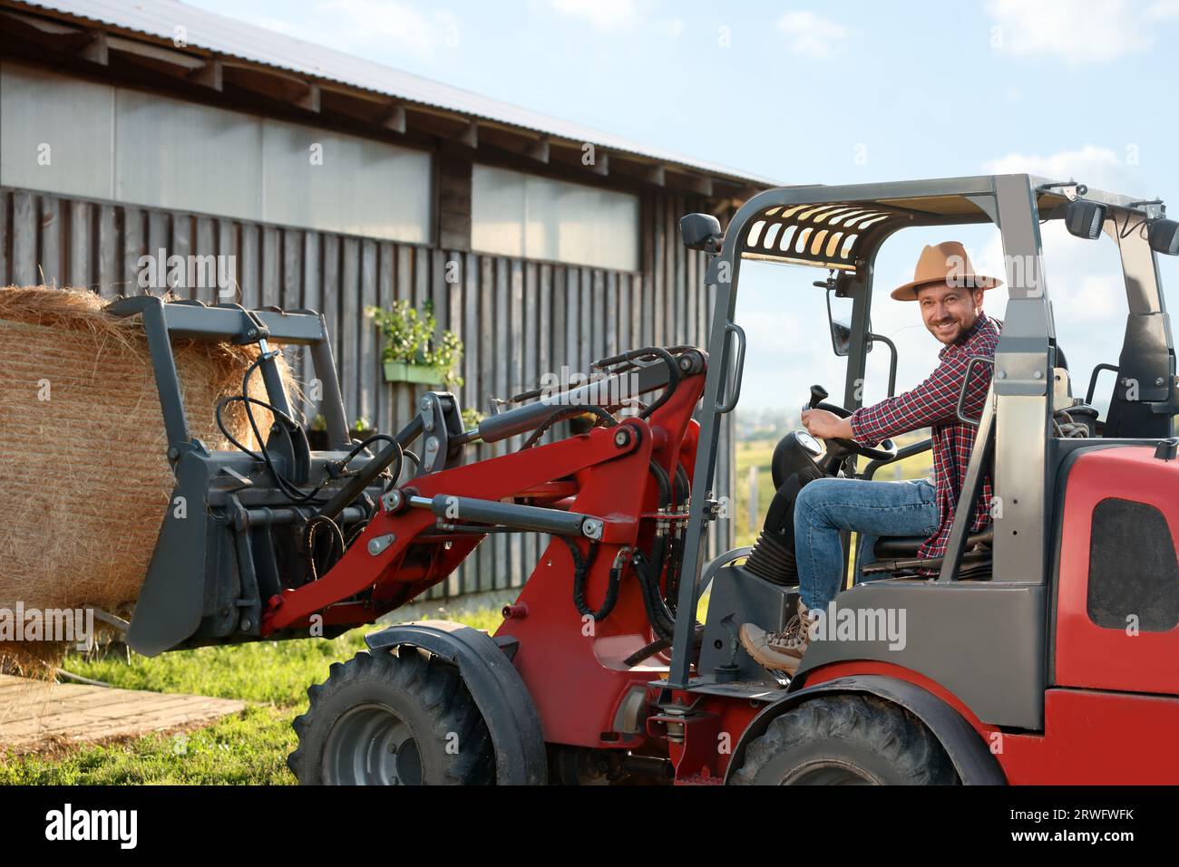 Man transporting hay in hi-res stock photography and images - Alamy