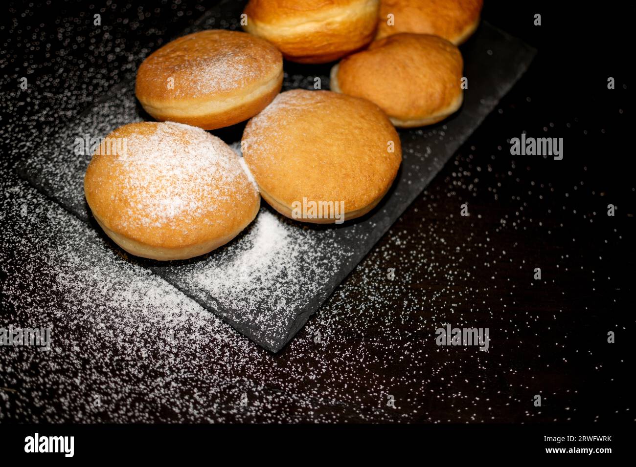 German Krapfen with drizzling glazed sprinkles in black elegant ...