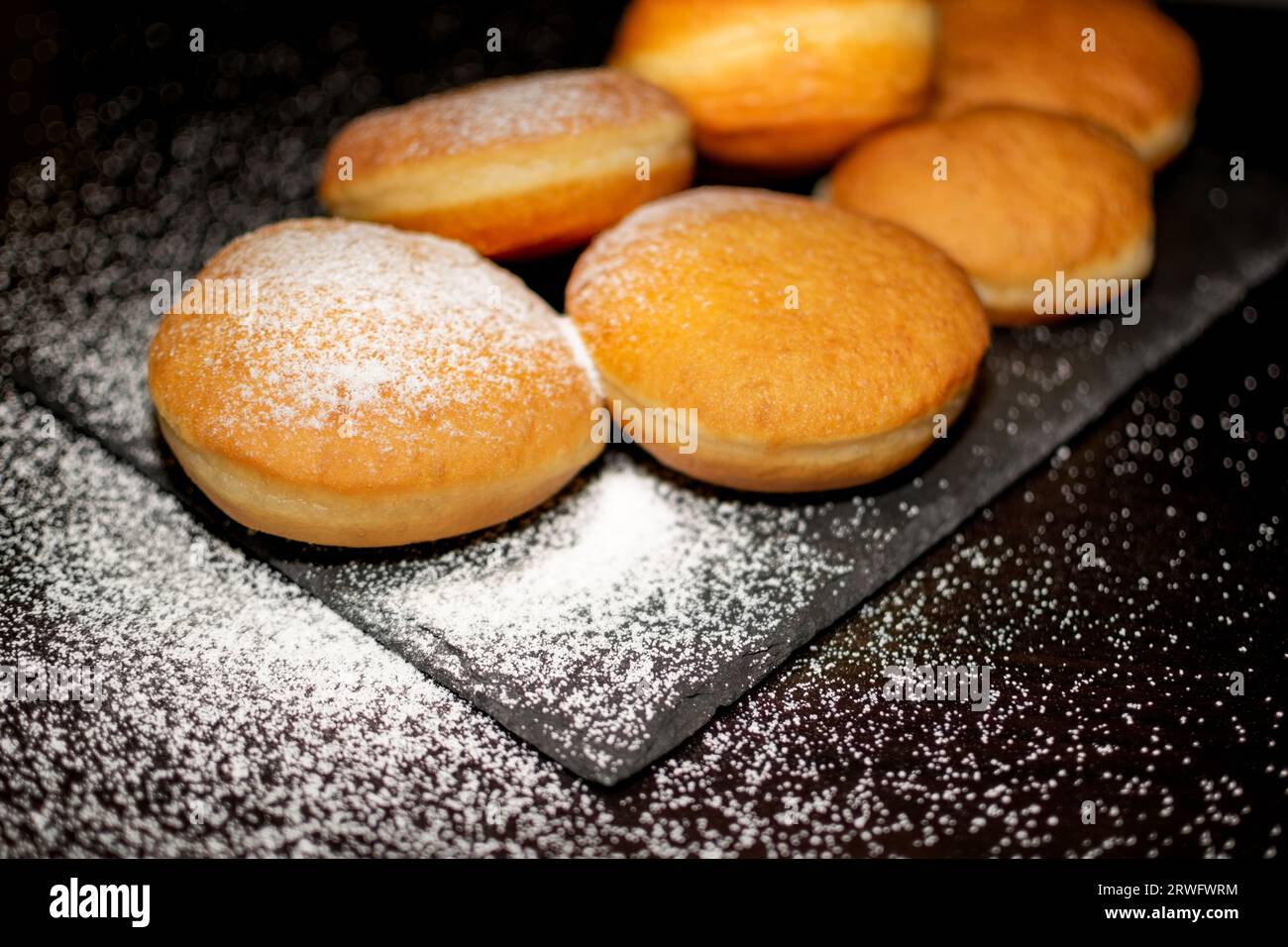 German Krapfen with drizzling glazed sprinkles in black elegant ...