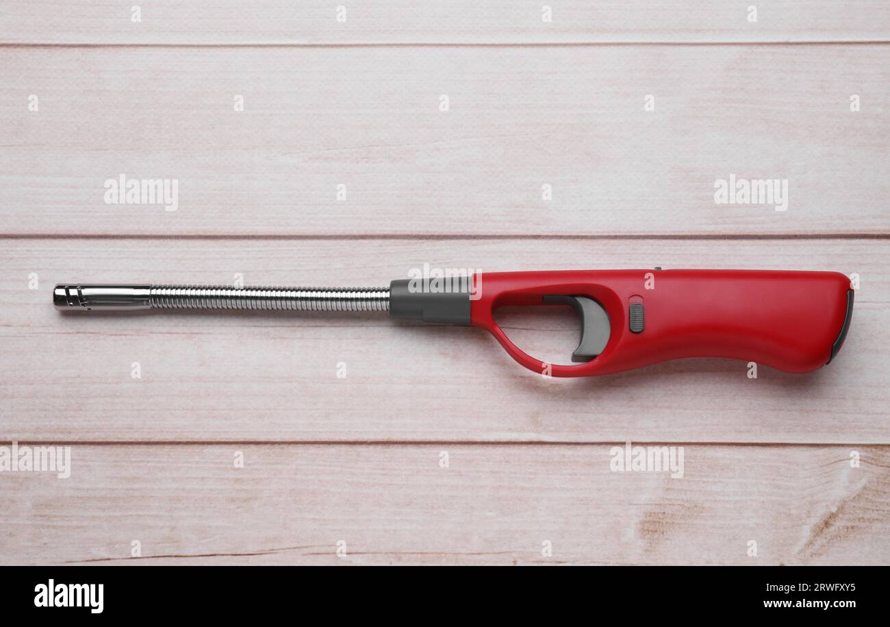 One gas lighter on white wooden table, top view Stock Photo - Alamy