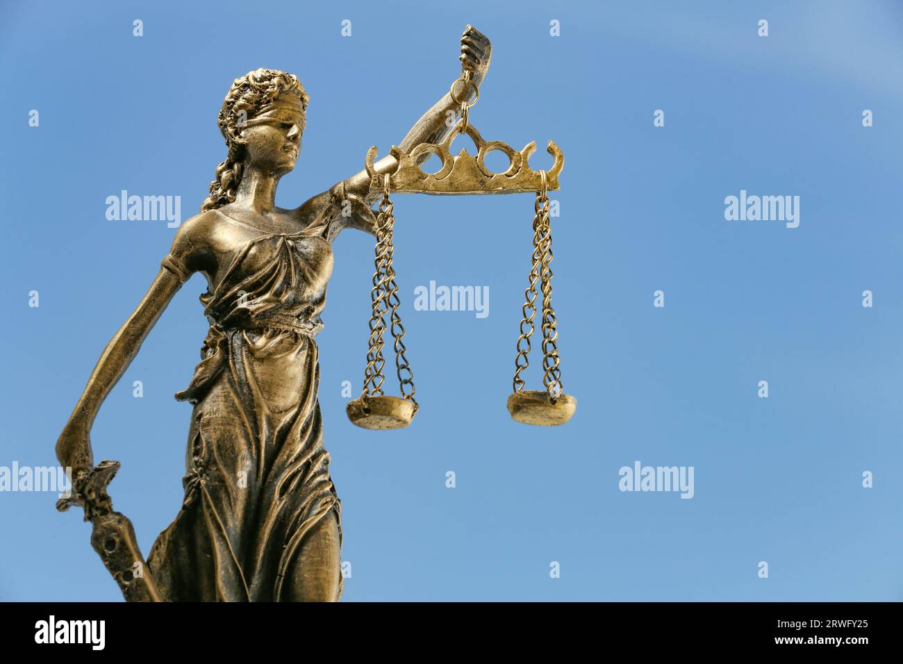 Symbol of fair treatment under law. Figure of Lady Justice against sky ...