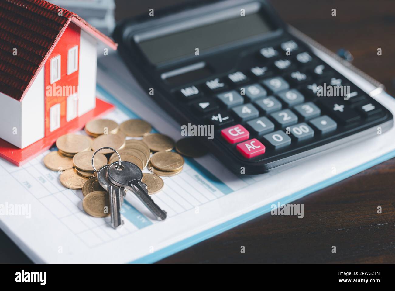 Coins with model home on wooden table, Save money concept, Property ...
