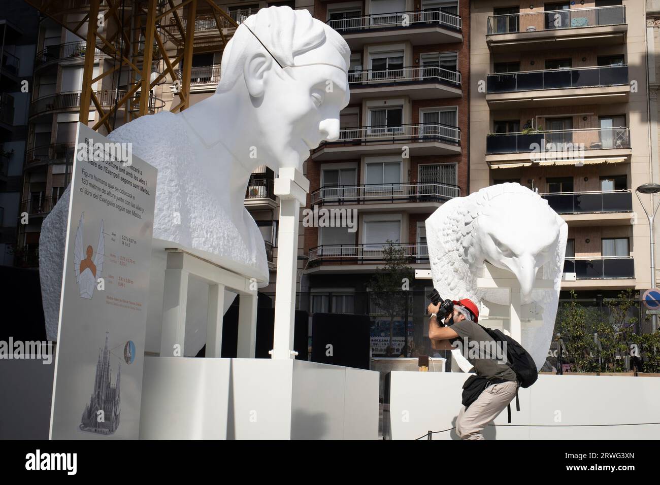 Workers of the Sagrada Familia next to the figures of the evangelist ...