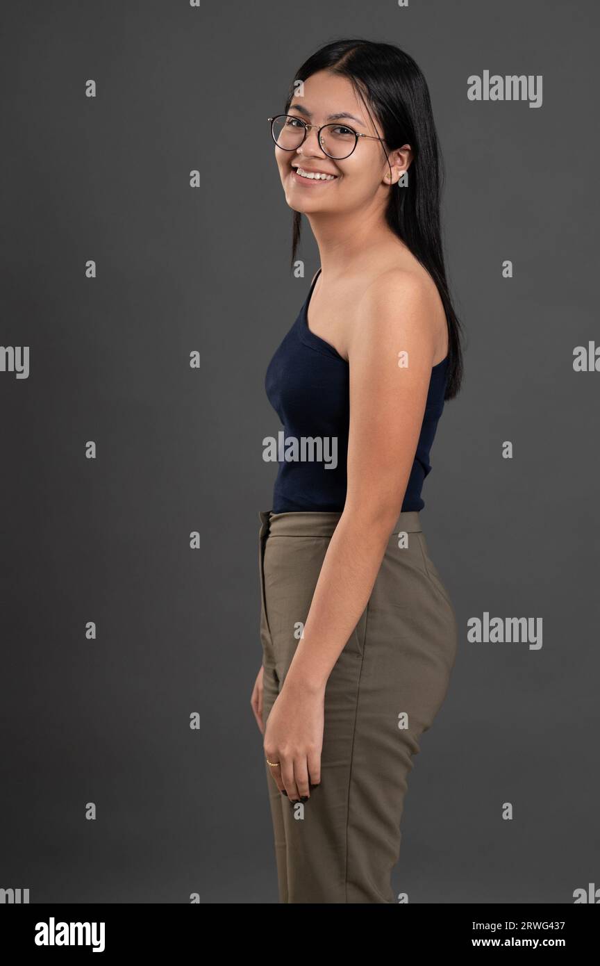 Happy smile latino girl in glasses profile view studio background Stock ...