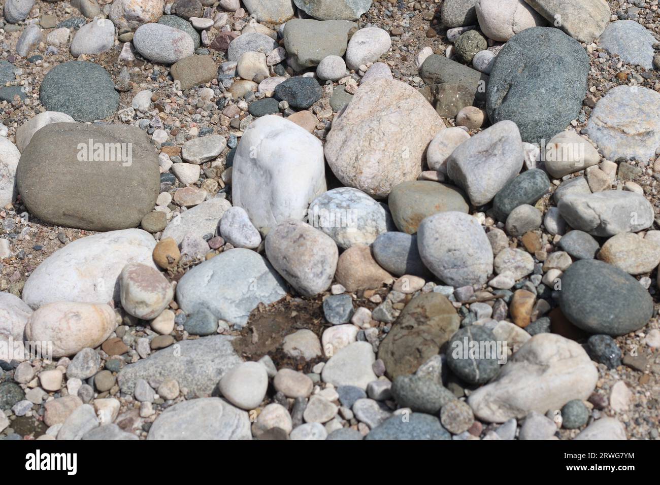 Different color and sizes stone in the river Stock Photo - Alamy