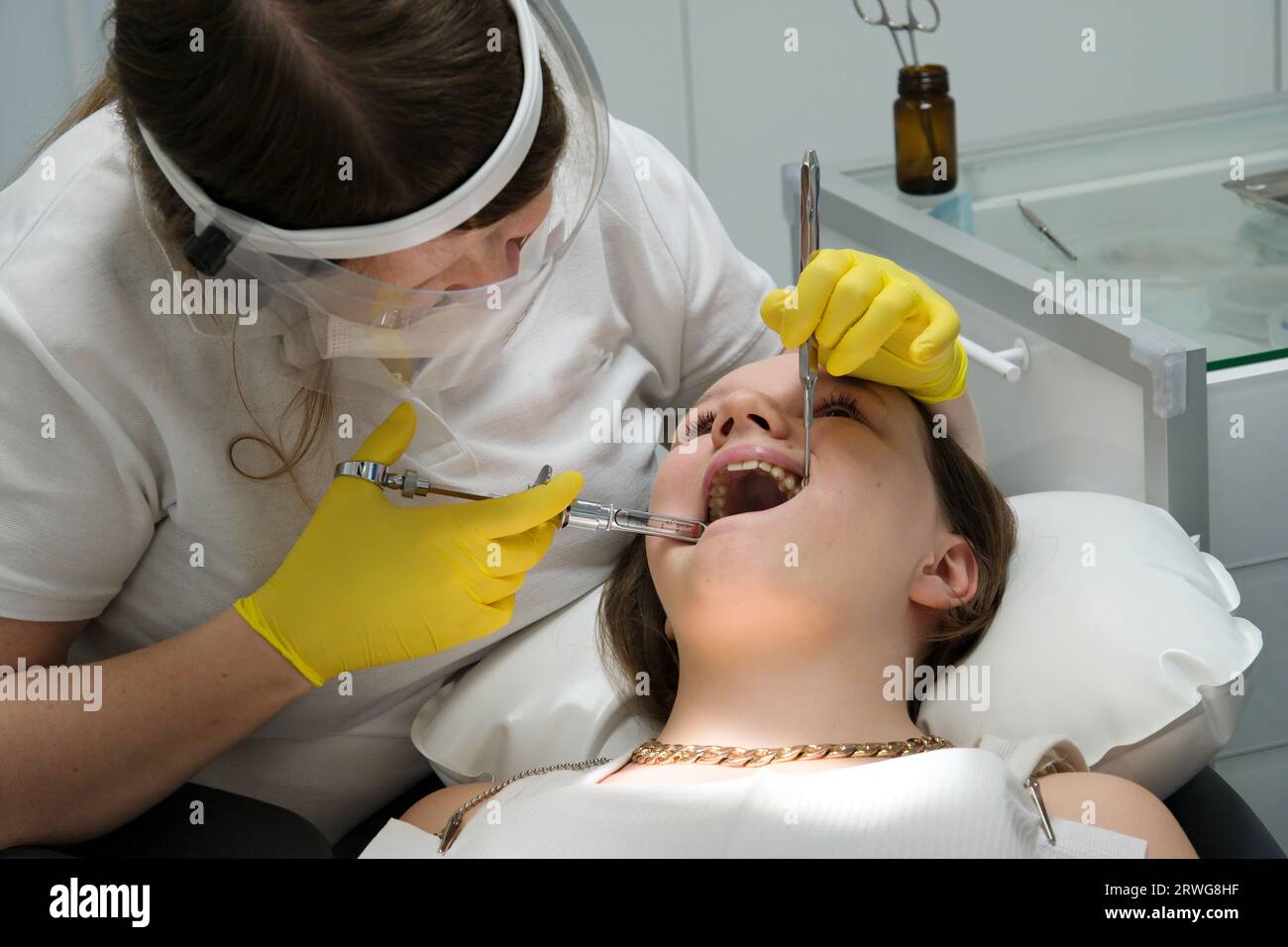 dental clinic, dental treatment, pain relief, giving an injection with ...