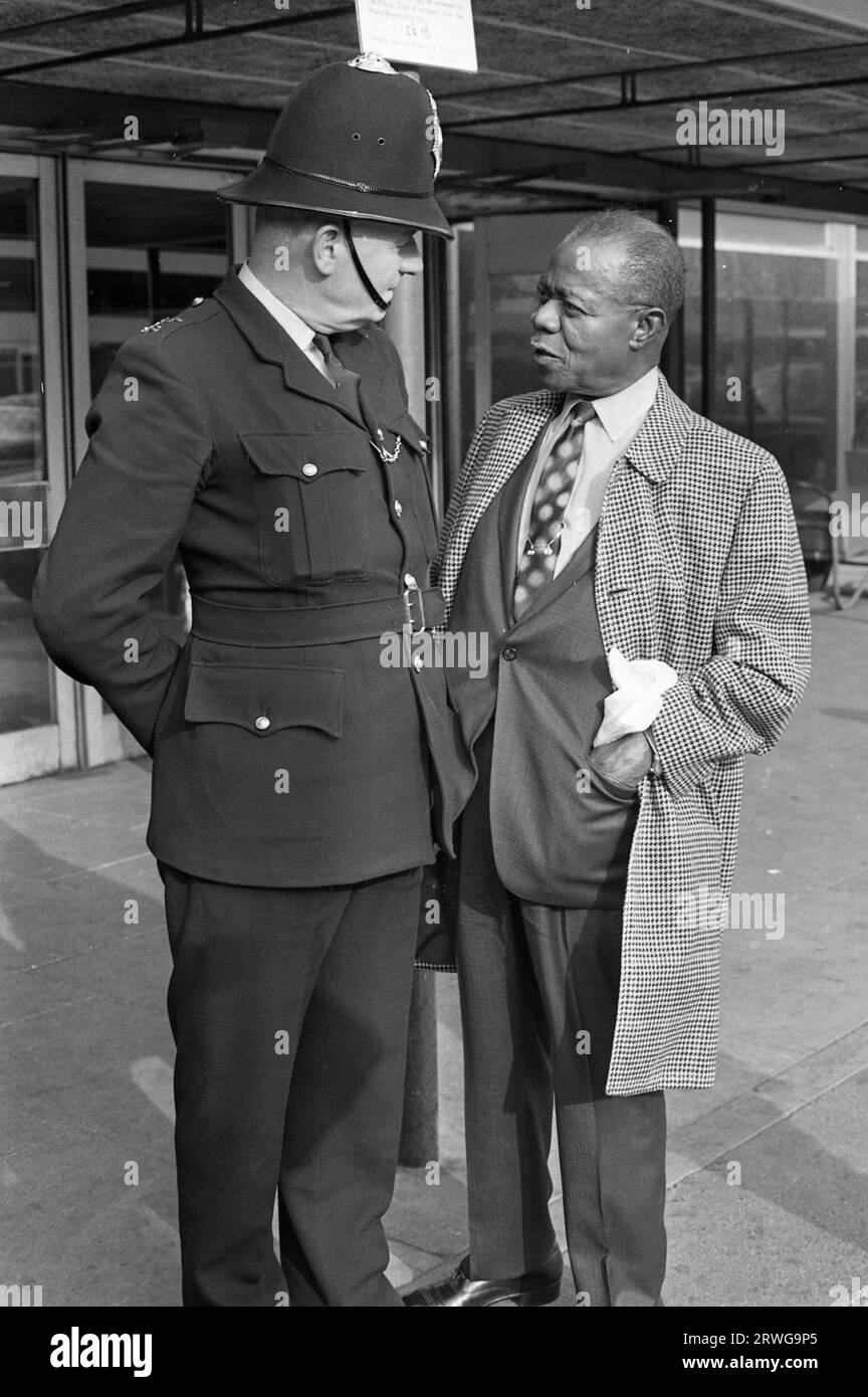 Louis Armstrong makes friends with a policeman at Heathrow Airport on ...