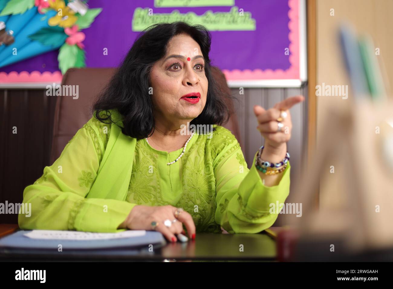 School Principal mam sitting happily, proud of the students of her ...