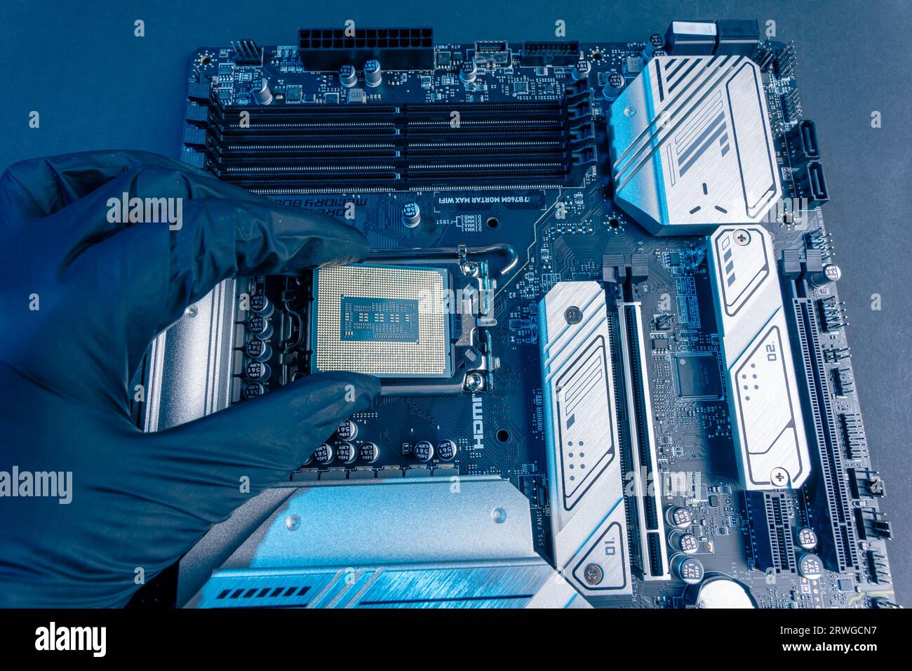 a computer processor in a gloved hand against the background of the ...