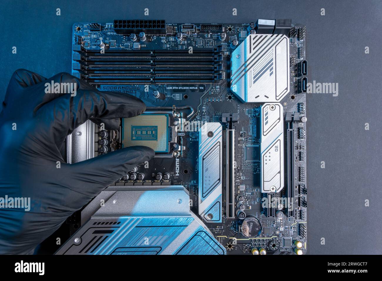 a computer processor in a gloved hand against the background of the ...