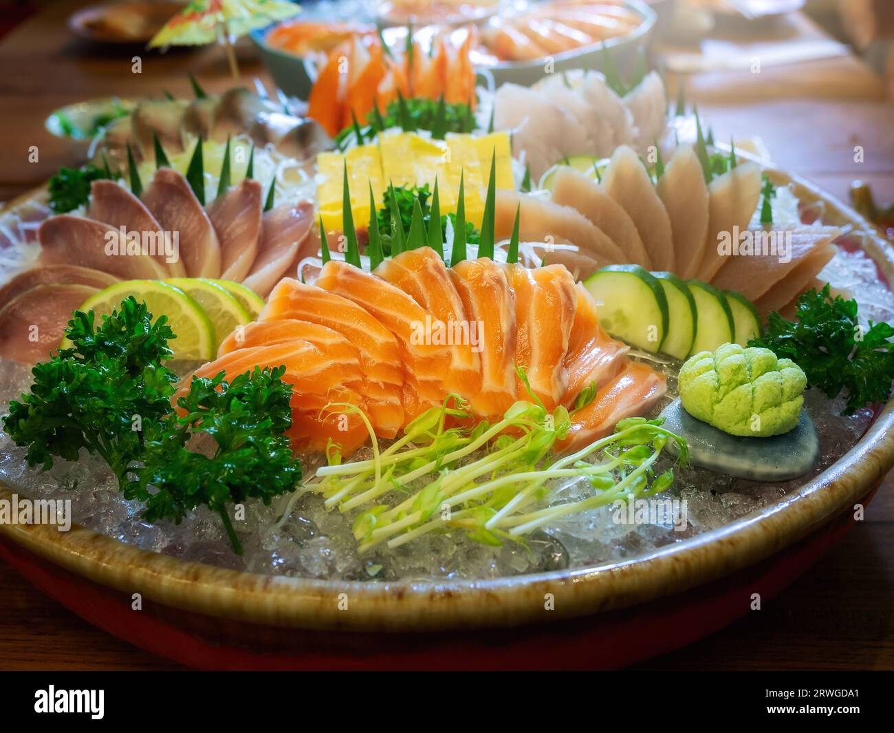 Fresh salmon, tuna and hamachi on ice in dish. Japanese food sashimi ...