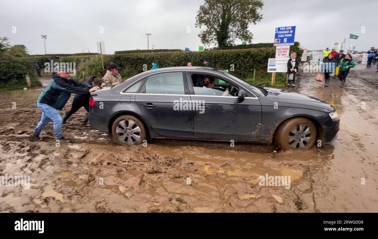 Stuck cars being pushed out of the mud at the Ploughing Championships ...