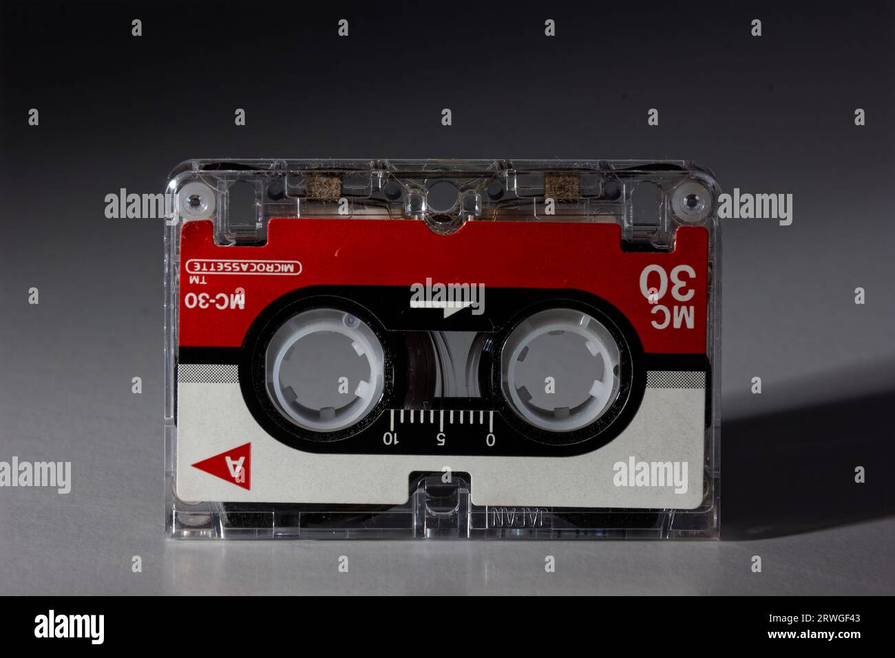 vintage analog audio micro cassette with transparent case and visible ...