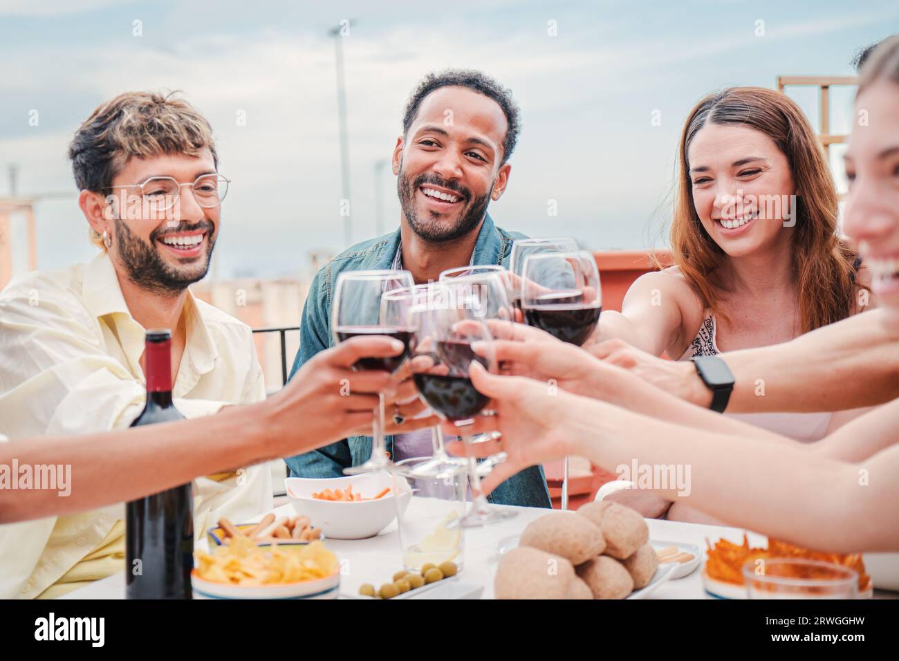 Diverse friends family laughing clinking hi-res stock photography and ...