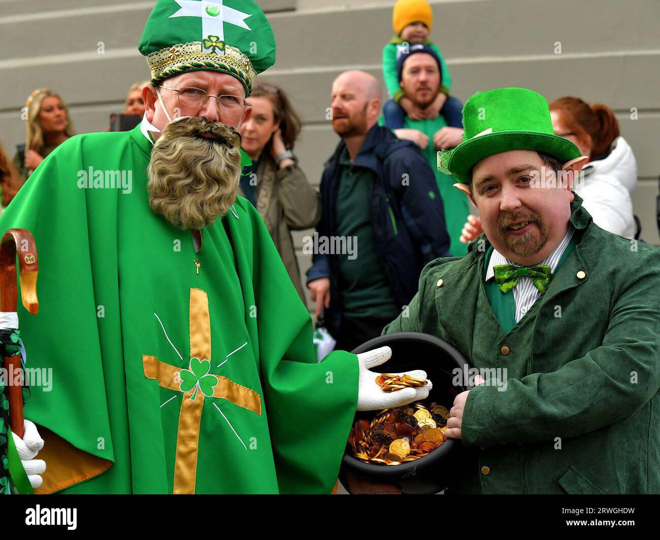 St Patrick meets a leprechaun holding a crock of gold at a St Patrick’s ...