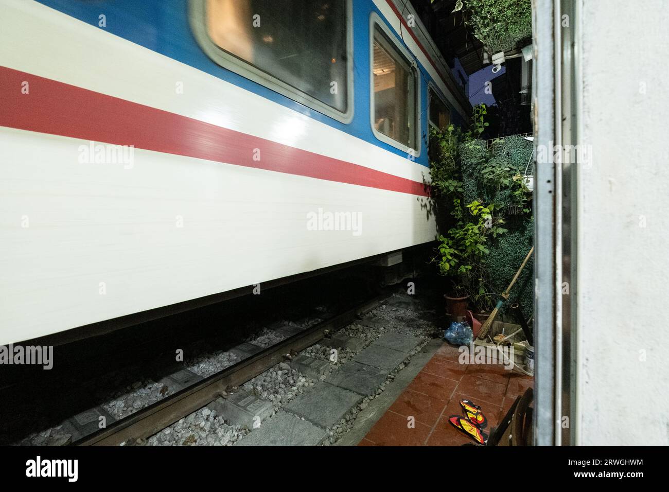 A train passes through Hanoi Train Street, Hanoi, Vietnam, in the ...