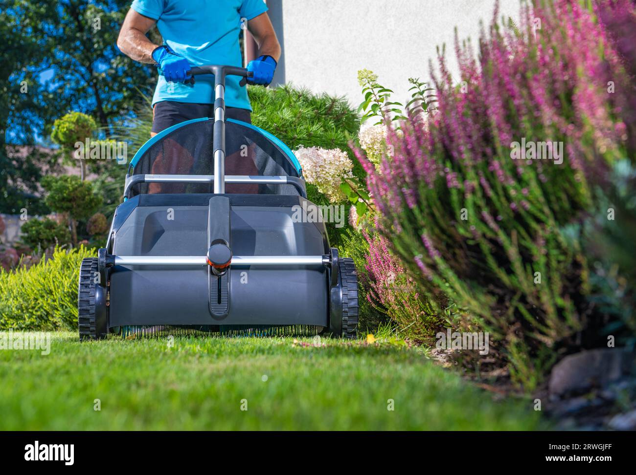 Garden Worker with Leaf and Lawn Collector Cleaning His Clients ...