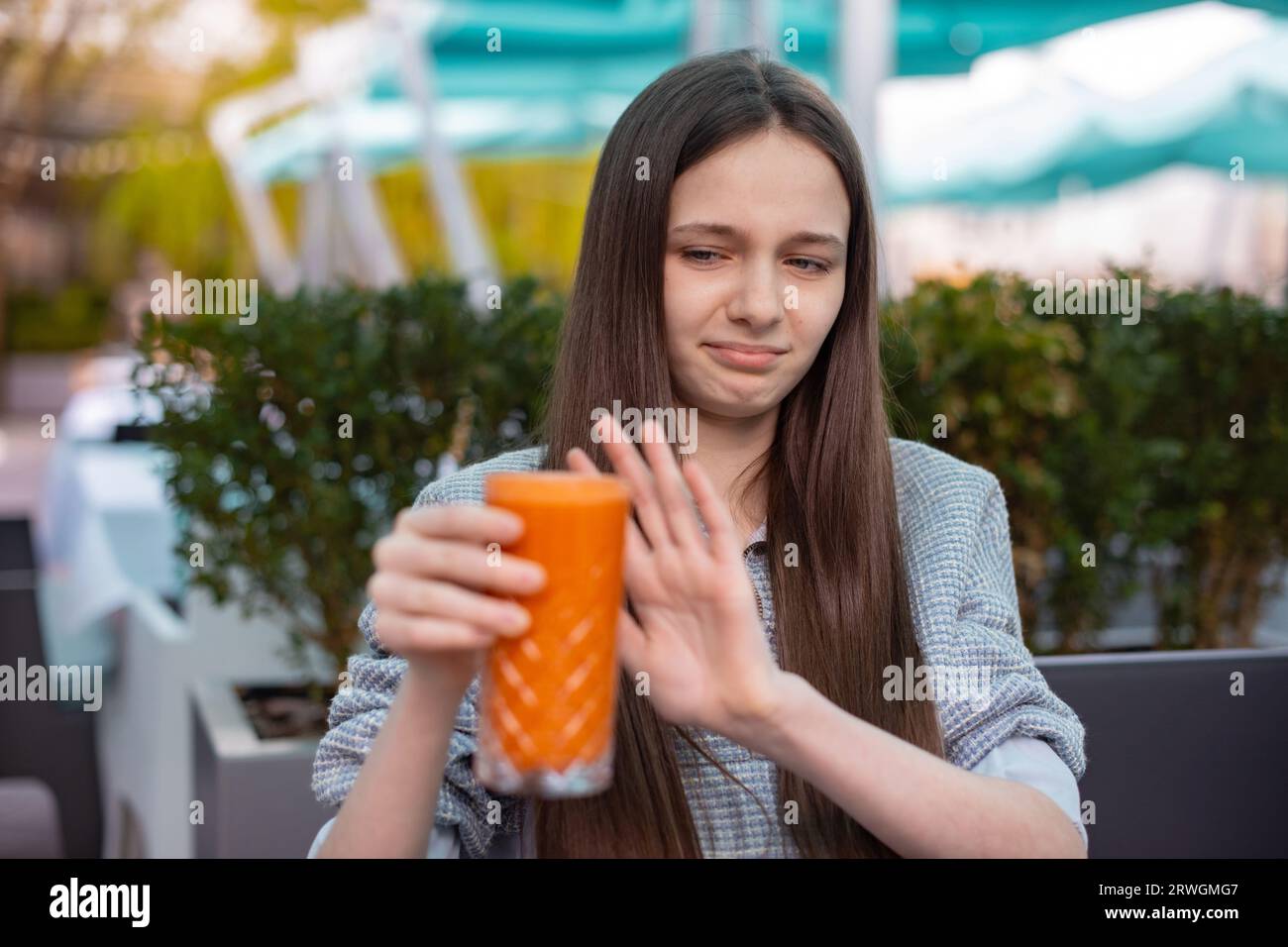 girl refuses to drink carrot fresh. teenager girl shows a sign of ...