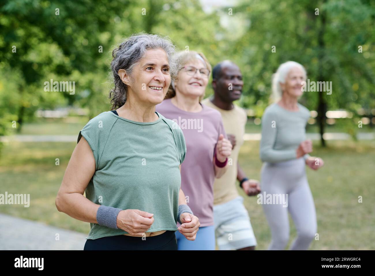 Group people jogging in park hi-res stock photography and images - Alamy