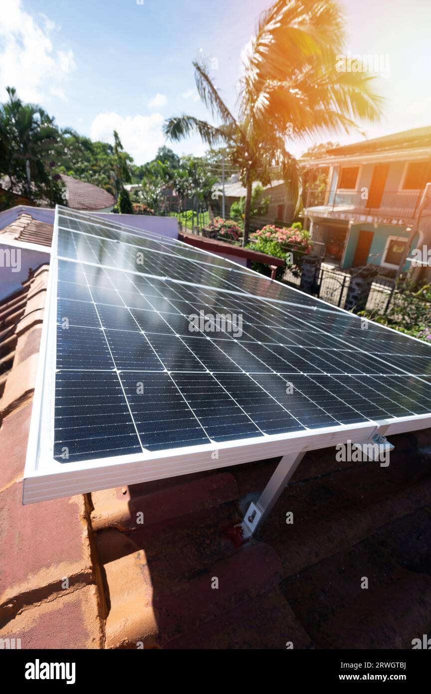 Solar panel generator array on house roof of residential on blue sky ...