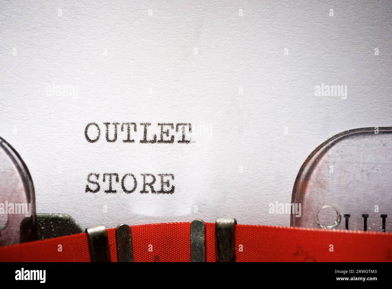 Outlet store text written with a typewriter Stock Photo - Alamy