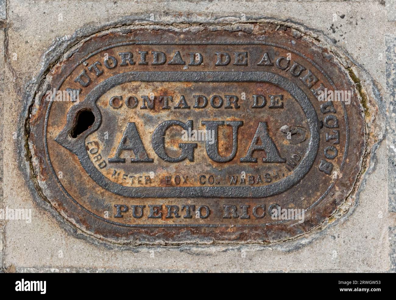 Old water meter cover embedded in the sidewalks of San Juan, Puerto ...
