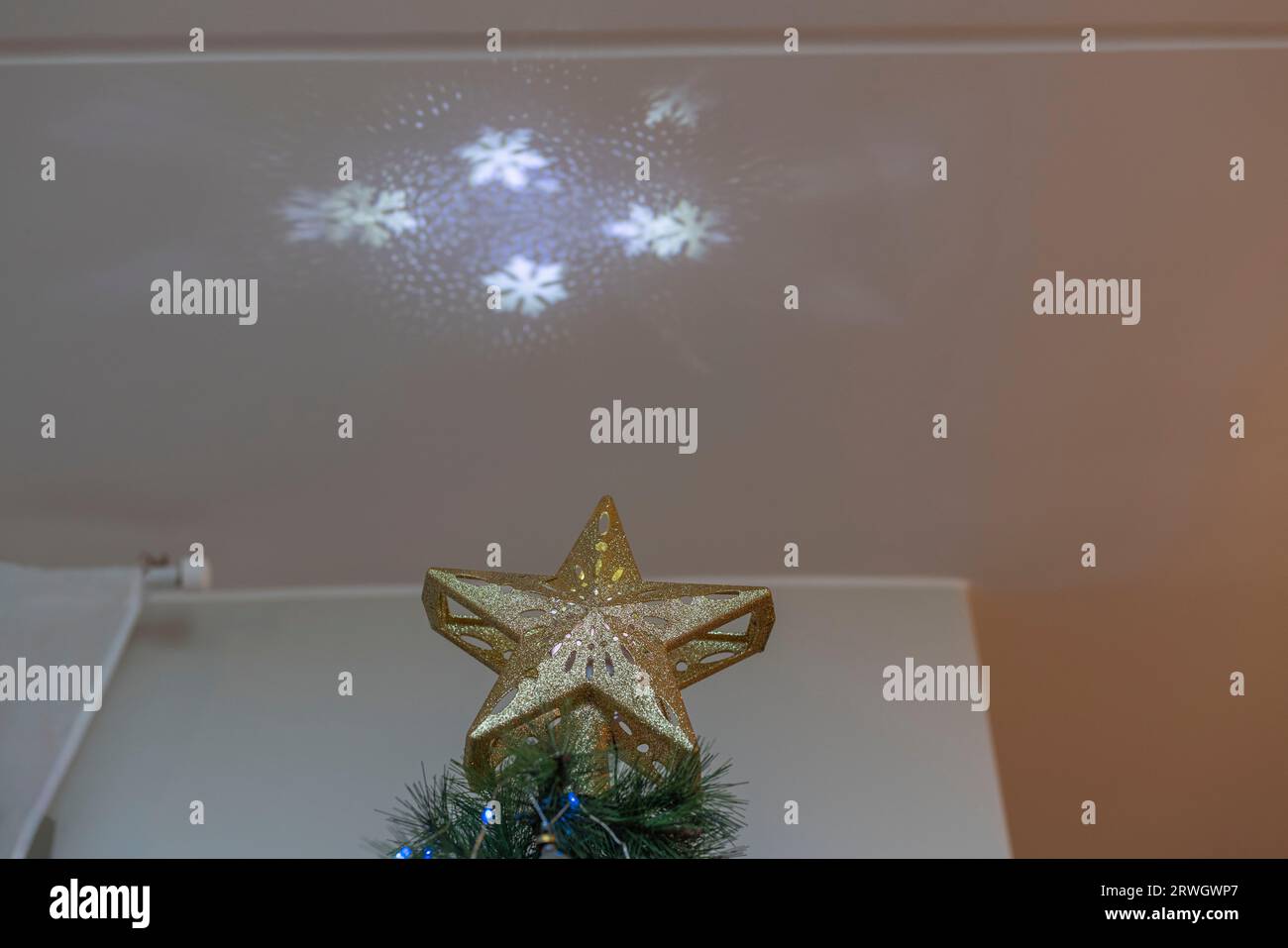 Beautiful view of gold star electrical top on Christmas tree that ...