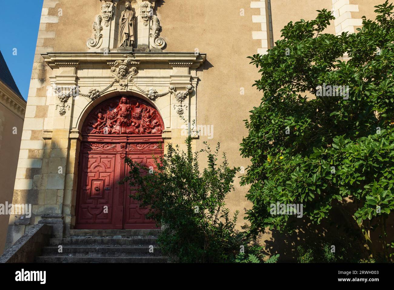Angers, France, 2023. The sculpted red door of the chapel of the 17th ...