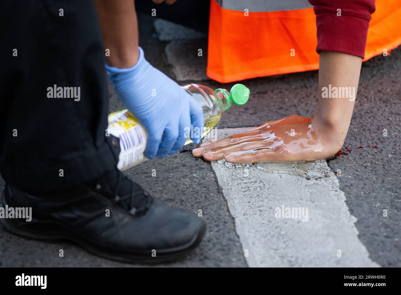 Berlin, Germany. 19th Sep, 2023. A police officer pours cooking oil on ...