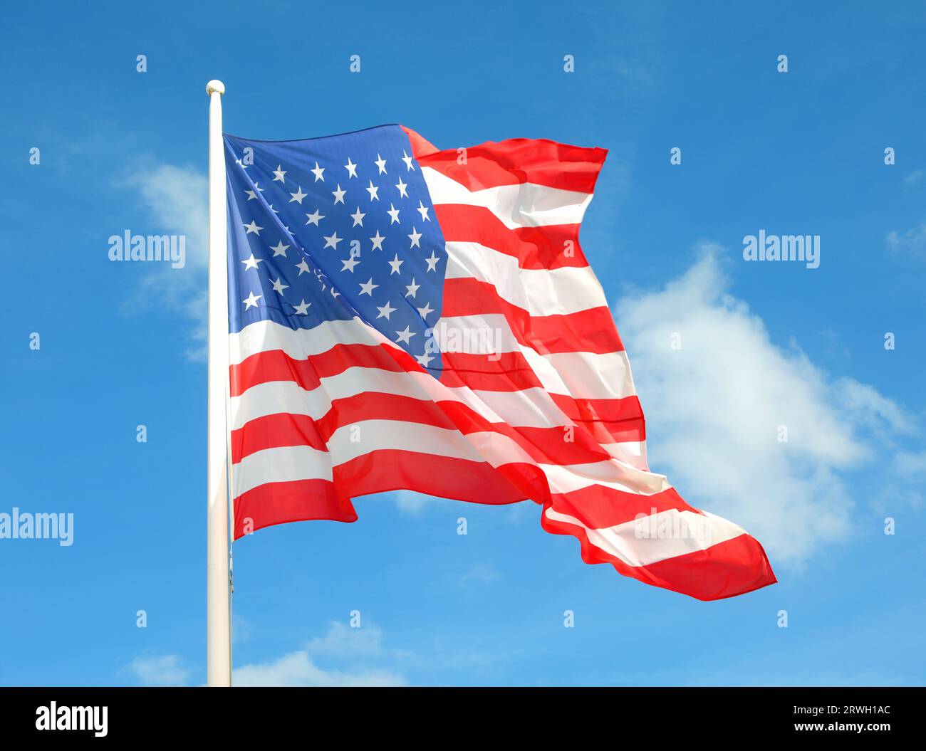 Vivid colors of the big US Flag waving in the wind and sky Stock Photo ...