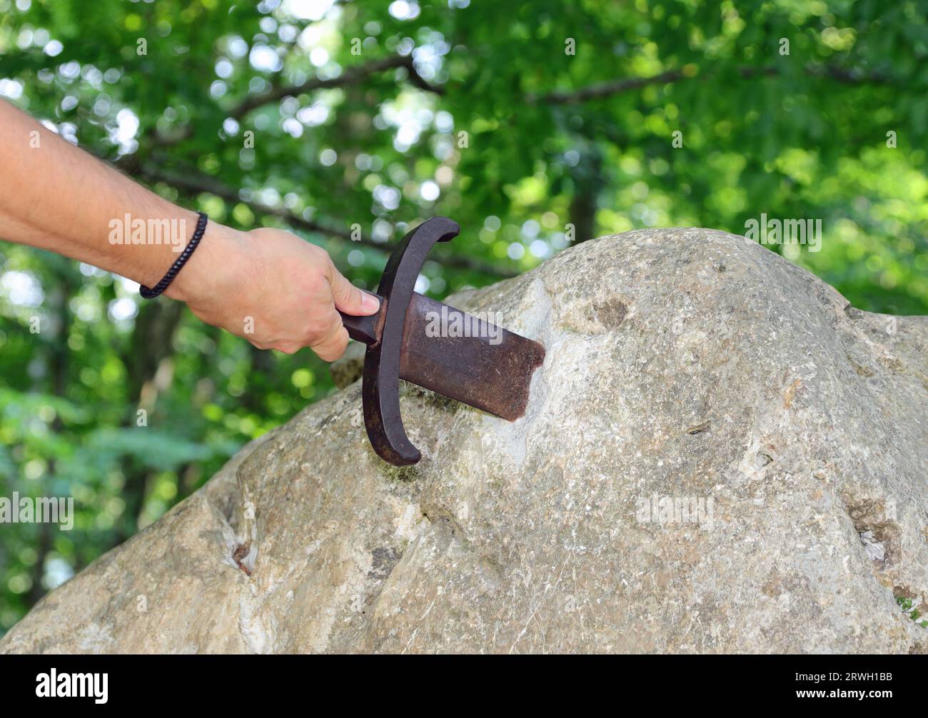 hand extracts the sword stuck in the rock as in the mythological story ...