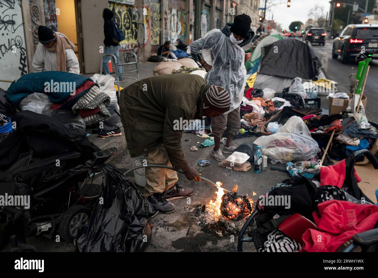 FILE - Robert Mason, a 56-year-old homeless man, warms up a piece of ...