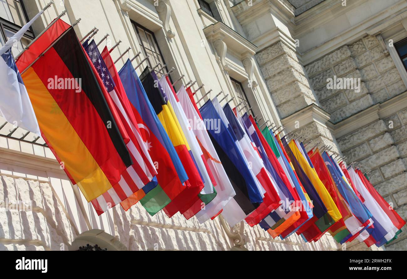 colorful flags of many world nations hanging outside government ...