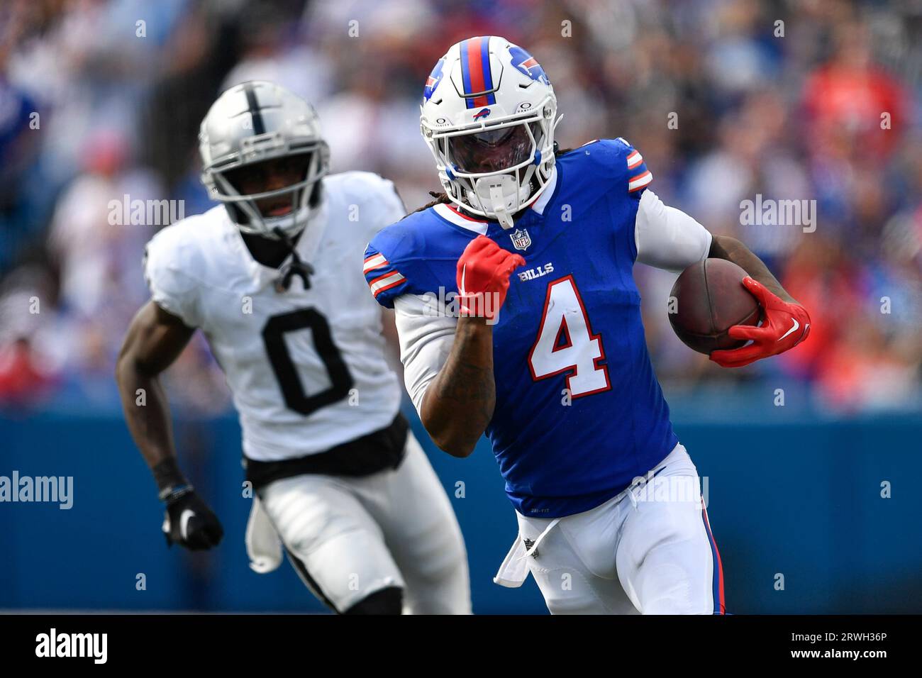 Buffalo Bills running back James Cook (4) runs with the ball while ...