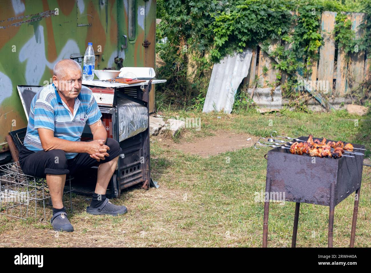 Belarus, Minsk - 11 july, 2023: A man looks at a barbecue close up ...