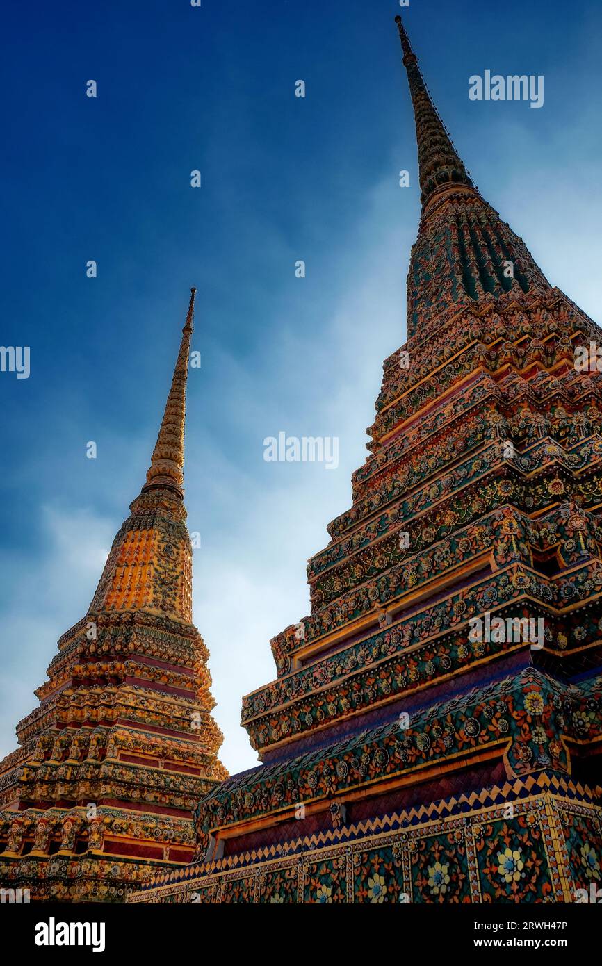 The image exhibits ornate temple spires in Thailand, festooned with ...